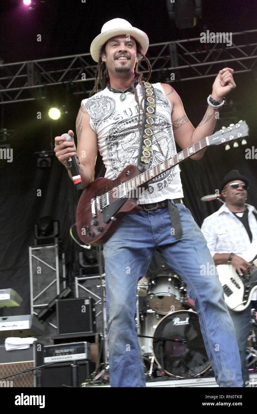 Musician Michael Franti is shown performing on stage during a "live ...