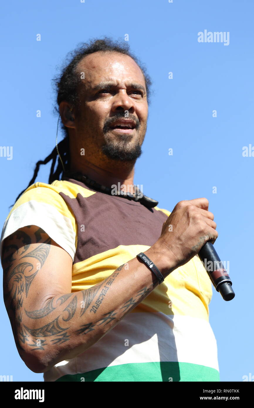 Musician Michael Franti is shown performing on stage during a "live ...