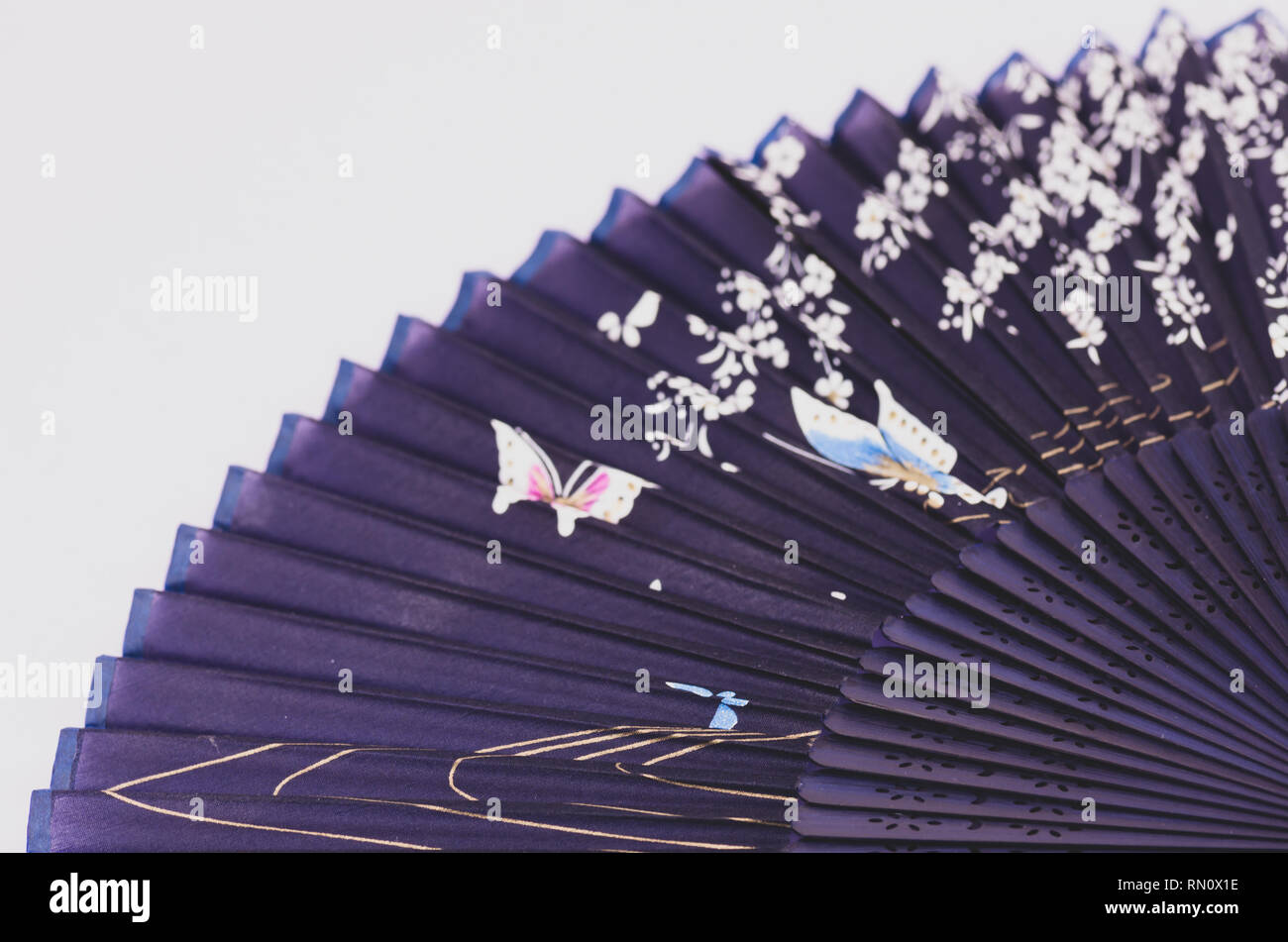 open dark blue floral theme decorated handheld folding fan Stock Photo ...