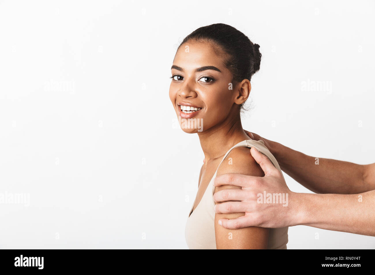 Young african woman sitting while man's hand holding her shoulders ...