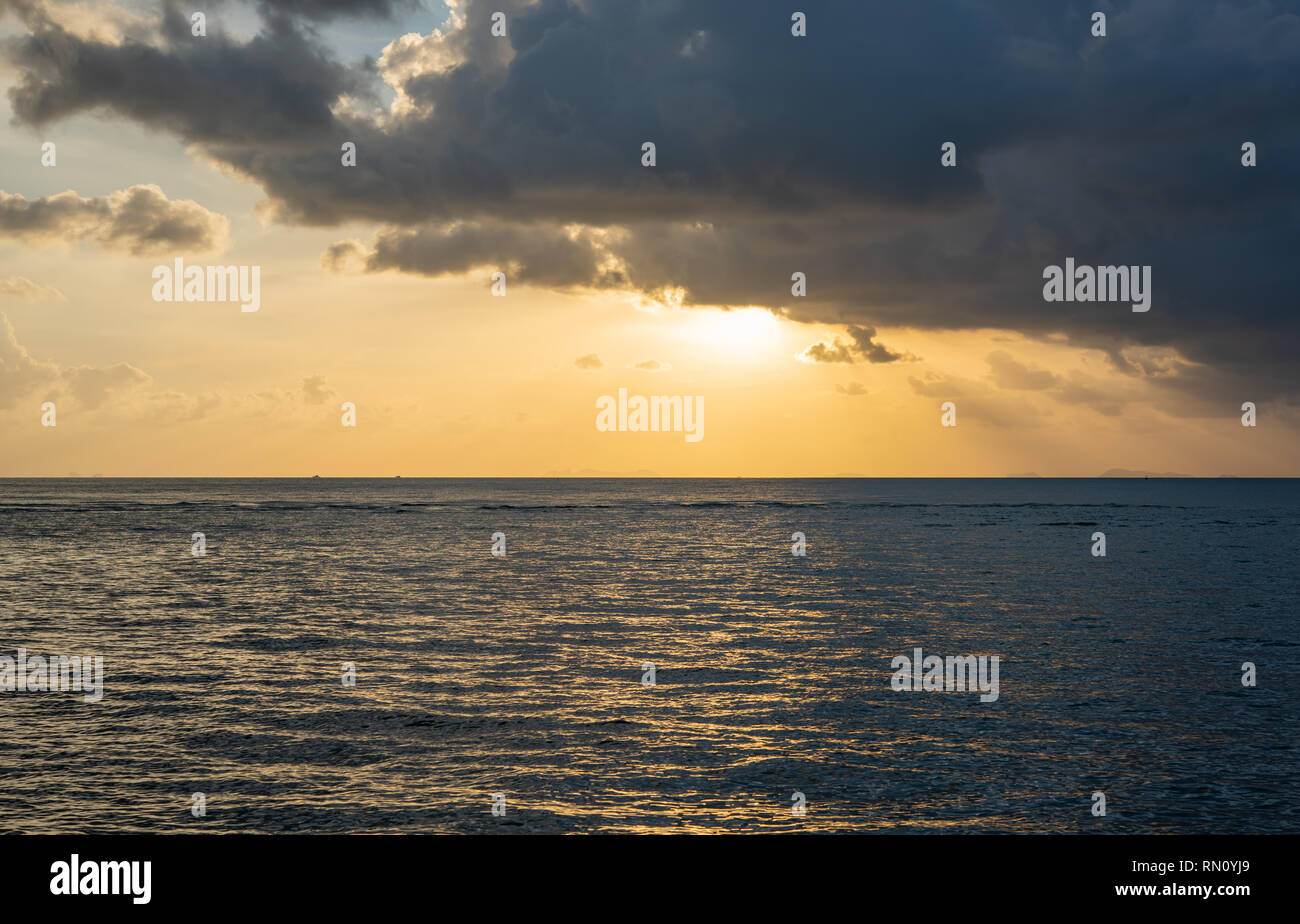 Sunset dramatic blue sky orange rain clouds background Stock Photo - Alamy