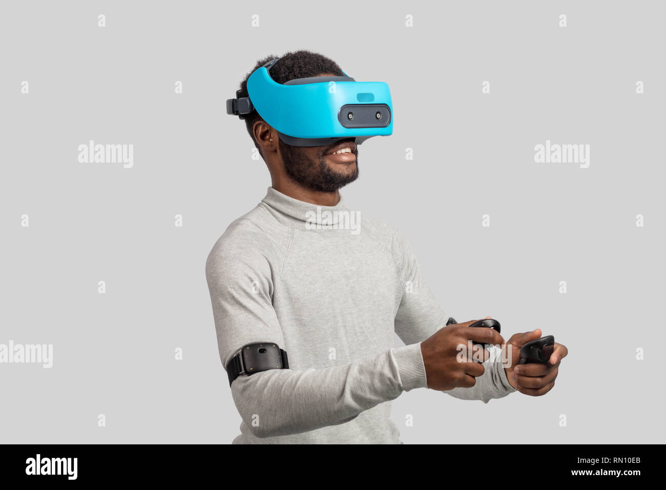 African american guy in casual wear plays racing game in VR headset ...