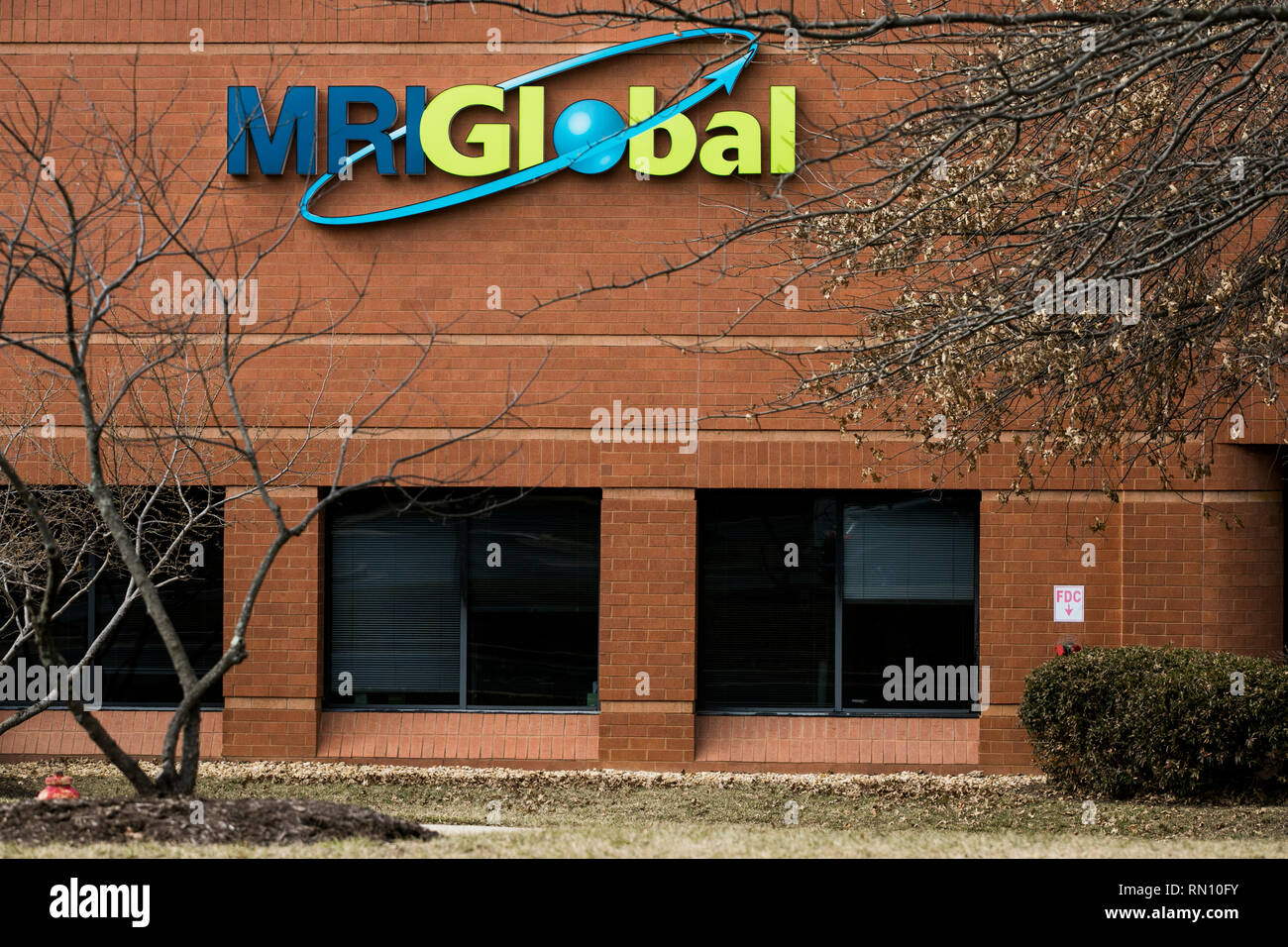 A logo sign outside of a facility occupied by MRIGlobal in Gaithersburg ...