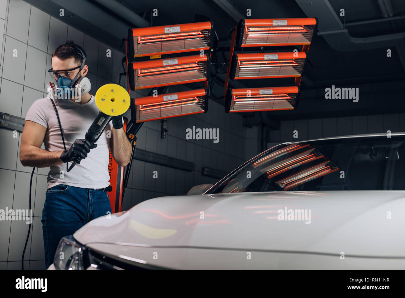 man offer good quality car polish. man is finishing paintwork. close up ...