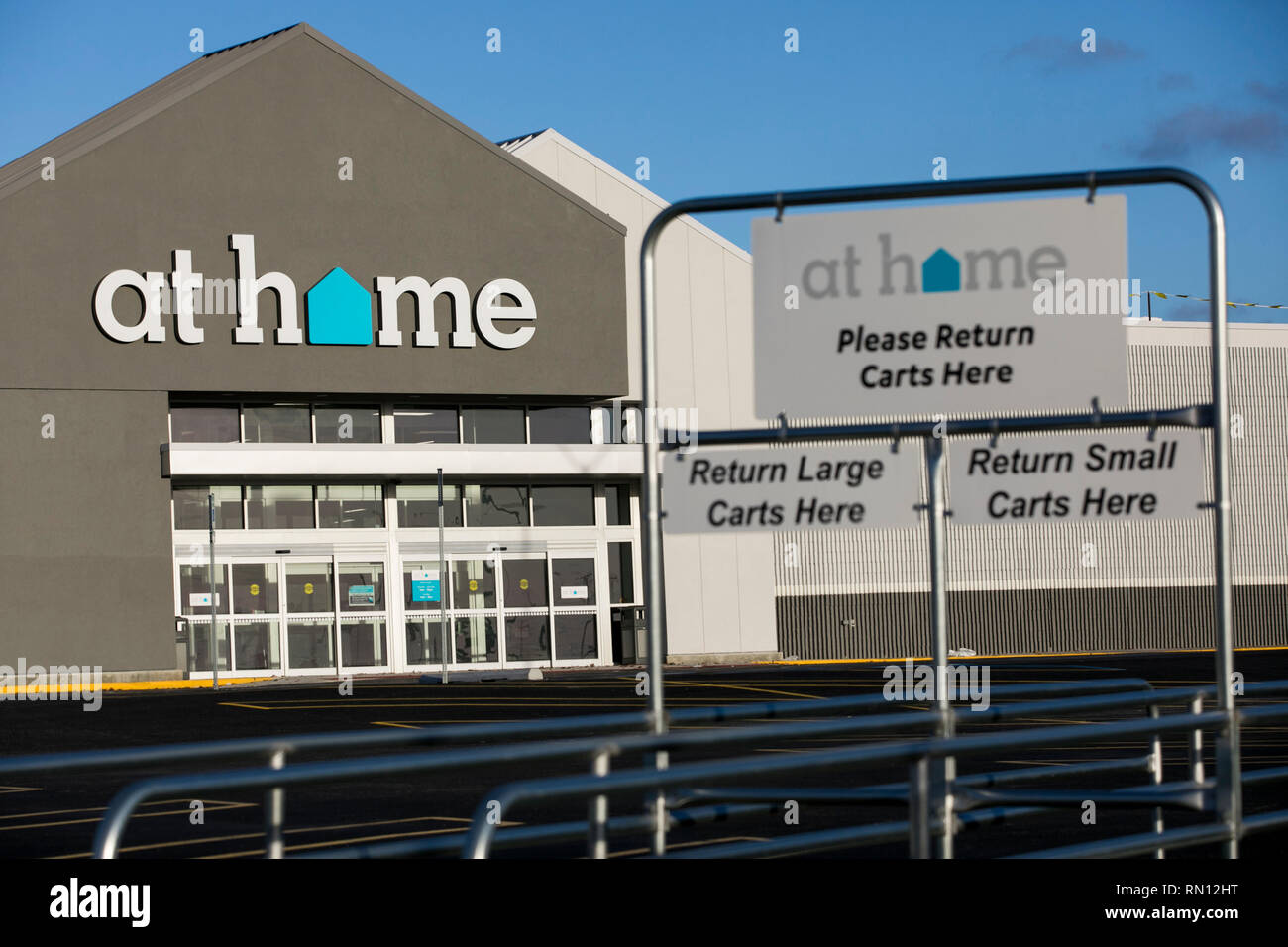 A logo sign outside of a At Home retail store location in Harrisburg ...