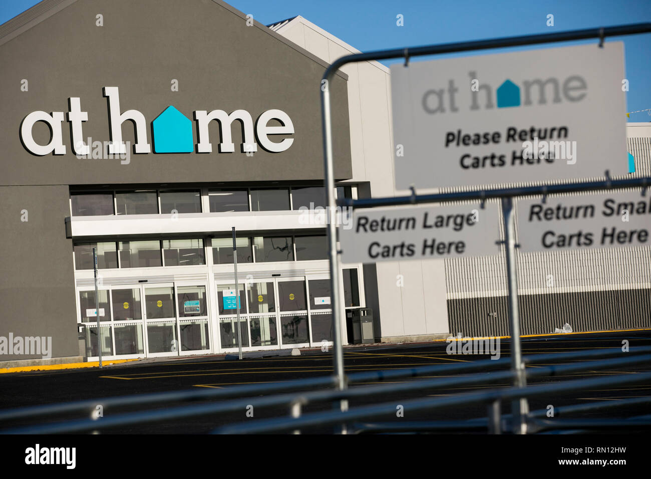 A logo sign outside of a At Home retail store location in Harrisburg ...