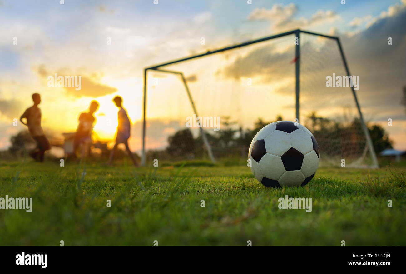 Kids playing soccer sun in sky hi-res stock photography and images - Alamy