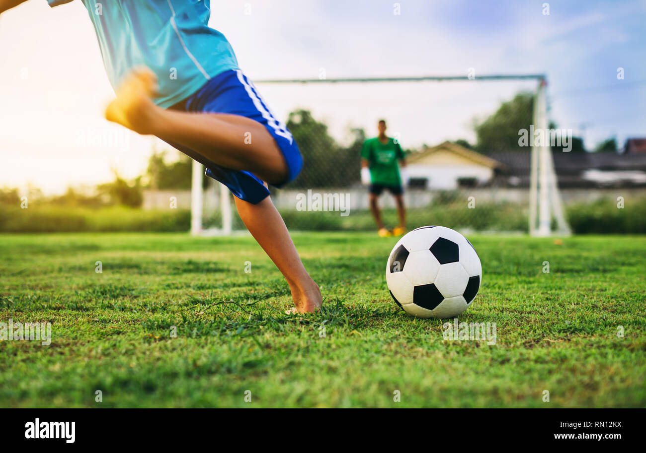 action sport outdoors of a group of kids having fun playing soccer ...