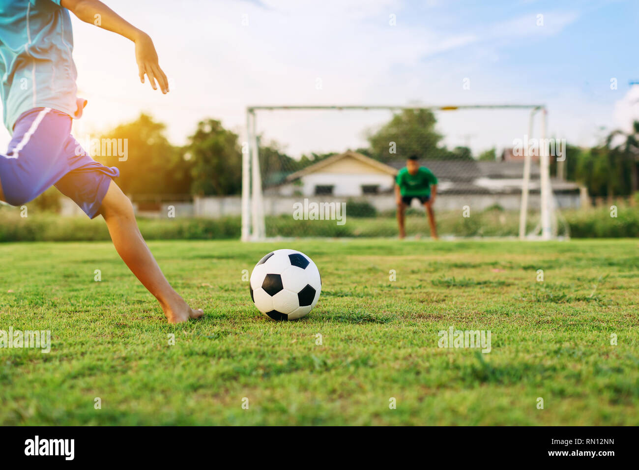 action sport outdoors of a group of kids having fun playing soccer ...