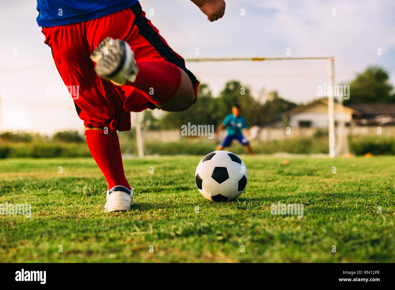 action sport outdoors of a group of kids having fun playing soccer ...