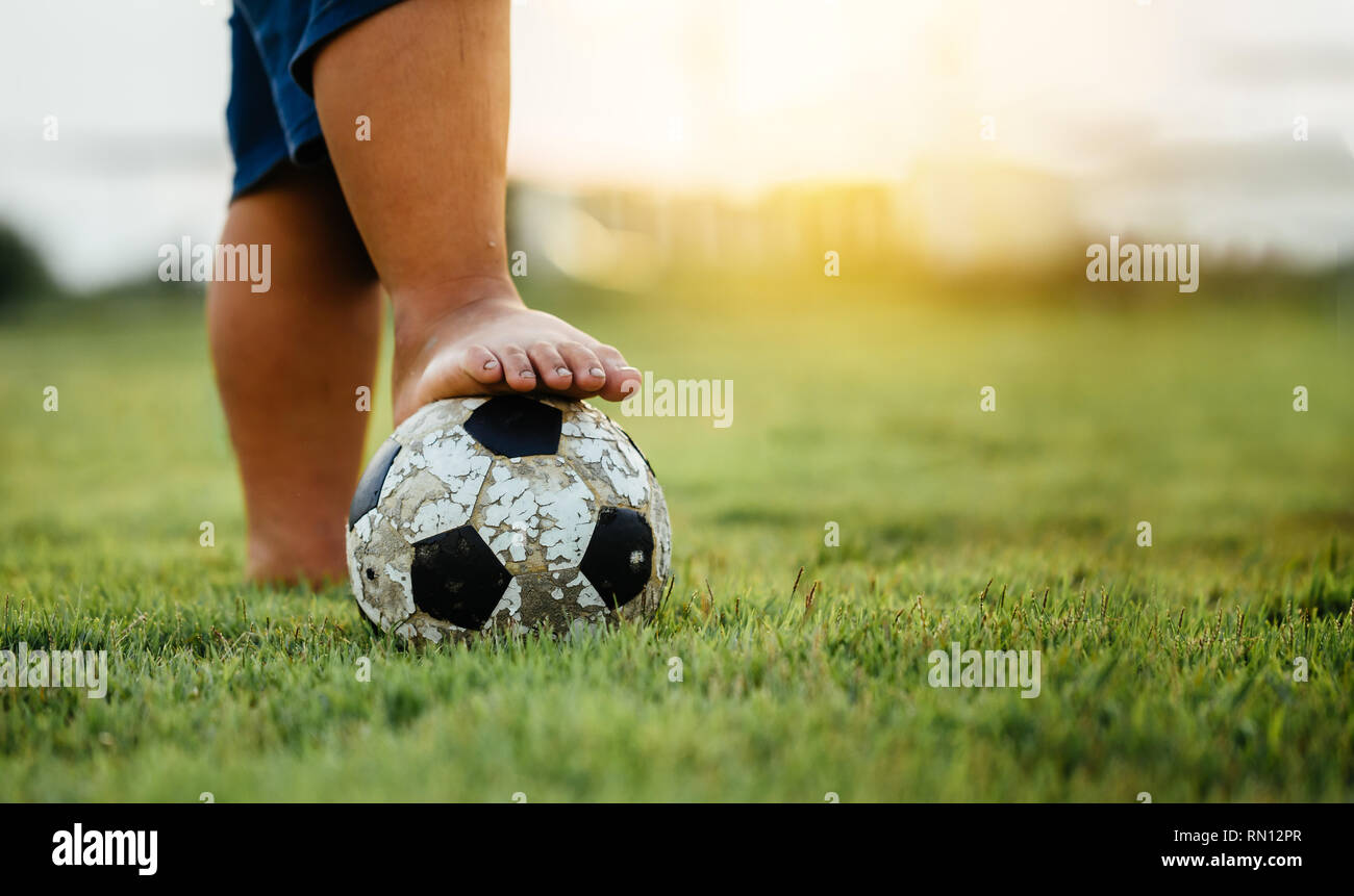 action sport outdoors of a group of kids having fun playing soccer ...