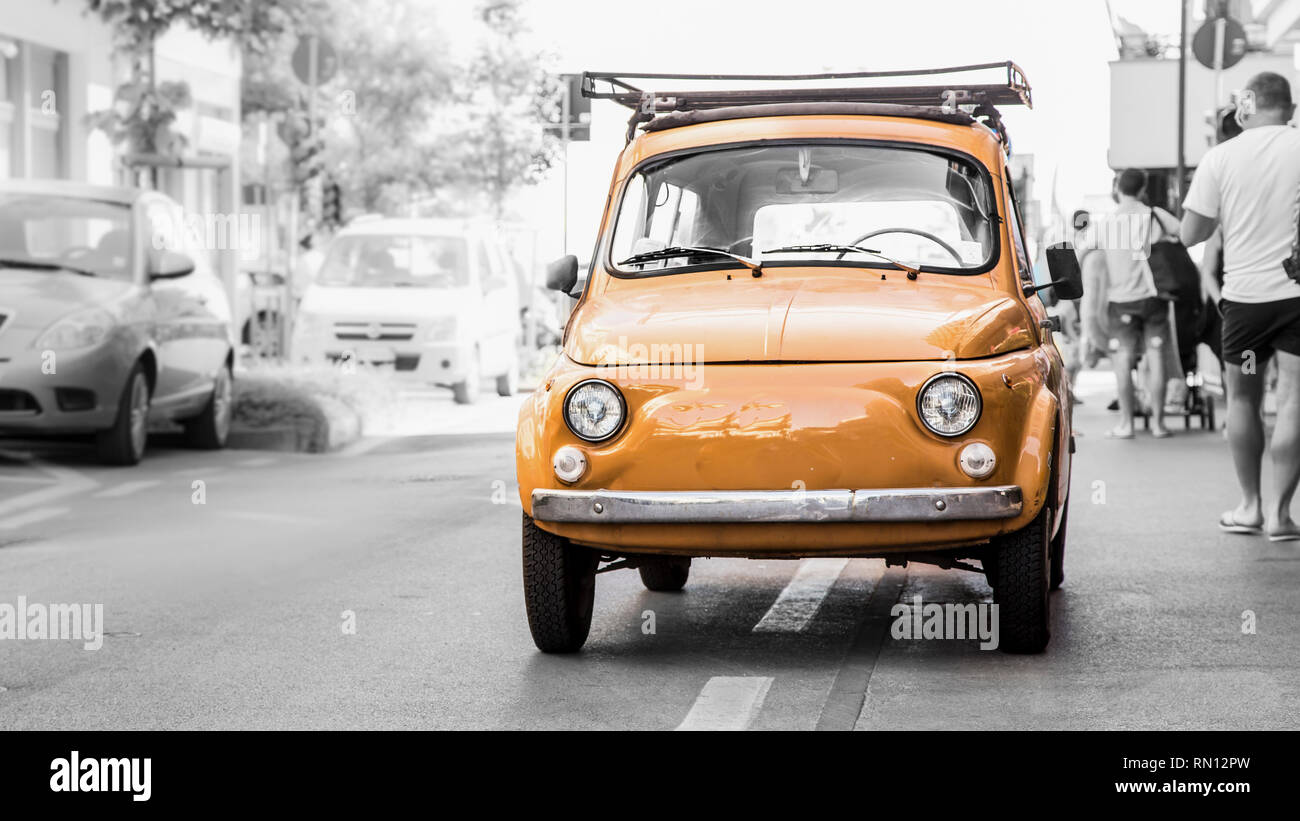 Italian cityscape with traditional small Italian yellow car, Rimini ...