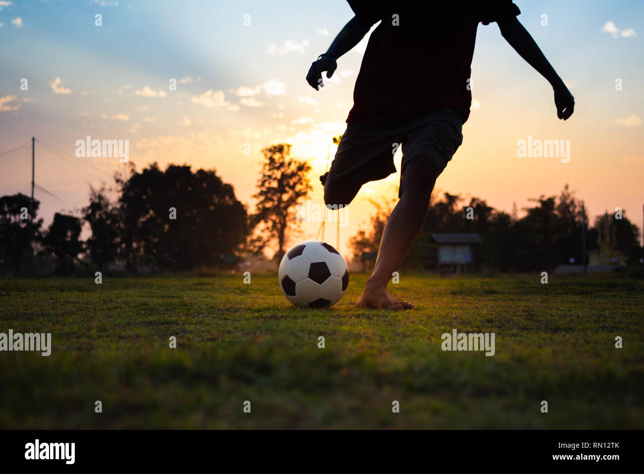 action sport outdoors of a group of kids having fun playing soccer ...