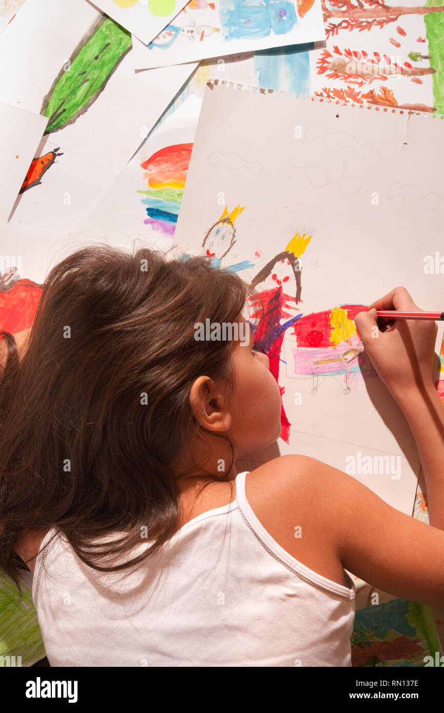 little girl draws among her drawings Stock Photo - Alamy