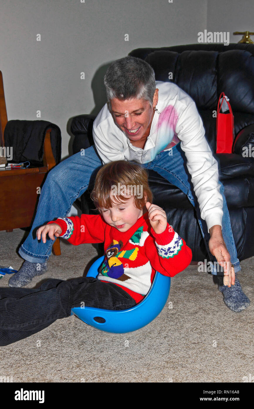 mother, son, young boy, spin; round seat; happy; fun; family; play ...