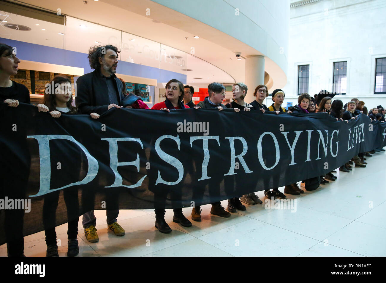 Activists are seen holding a banner during the protest. Hundreds of ...
