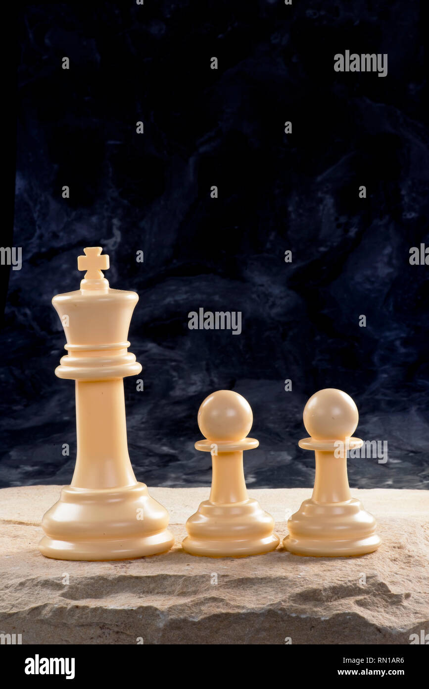 Chess king and his pawns Stock Photo - Alamy