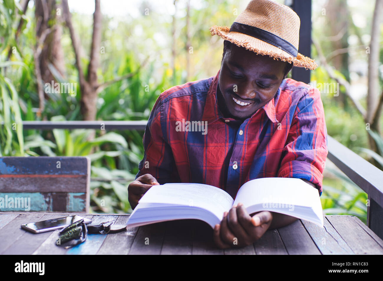 African american man reading hi-res stock photography and images - Alamy