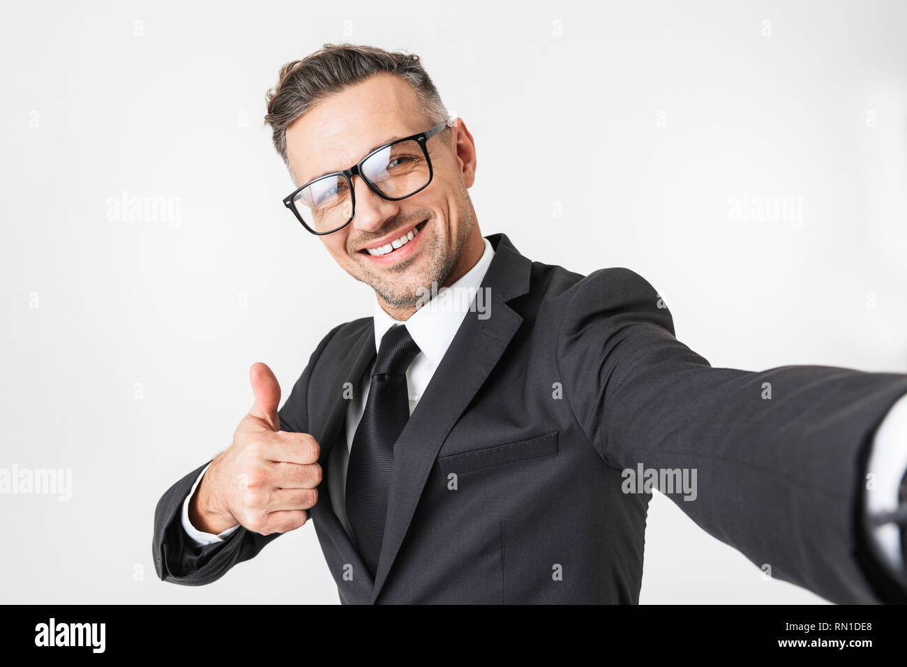 Image of a handsome cheerful business man isolated over white wall ...