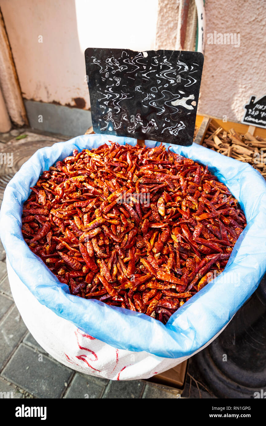 Dried red chilli peppers in the bag for sale at the market, close up ...