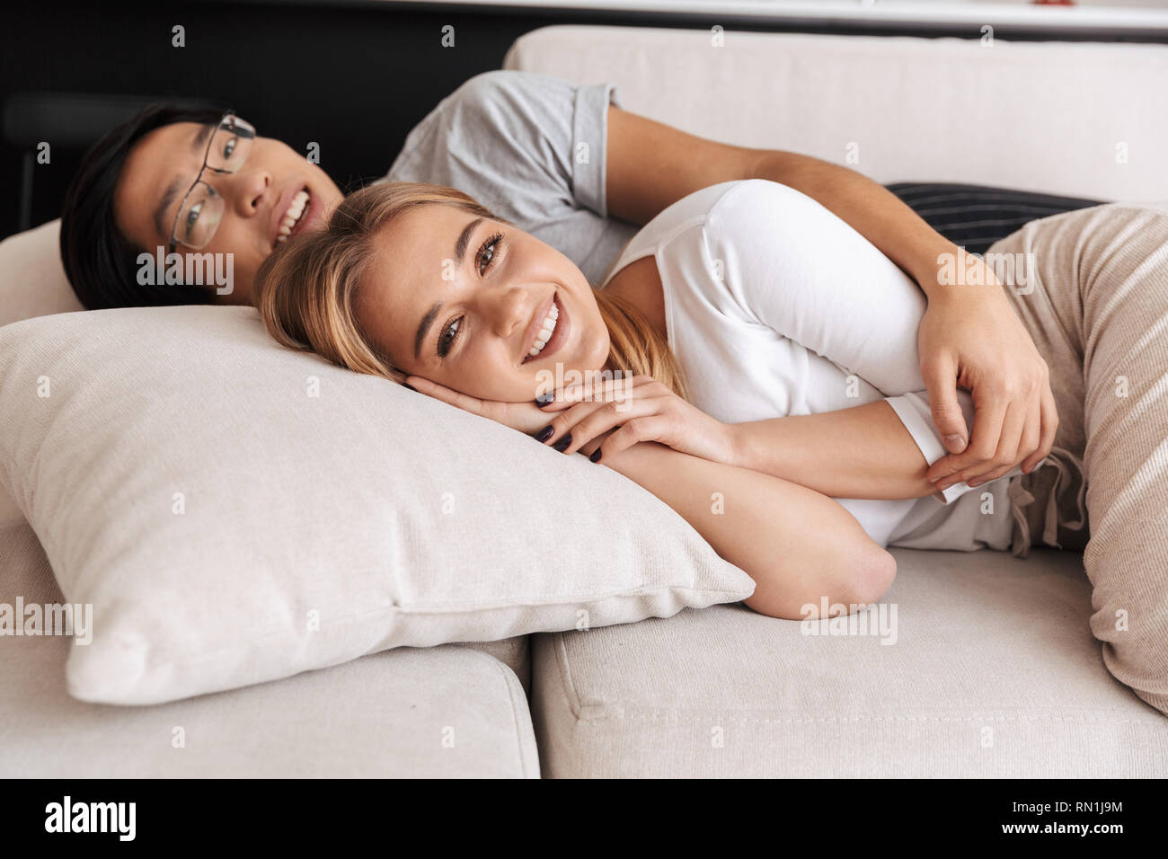 Mature couple laying on couch hi-res stock photography and images - Alamy