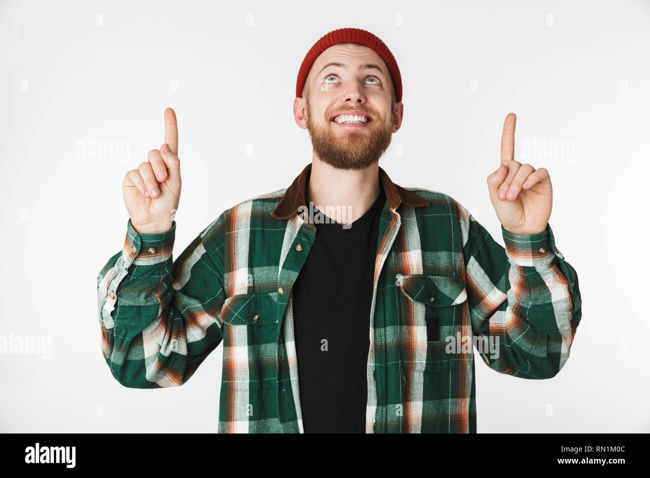 Portrait of cheerful man wearing hat and plaid shirt smiling while ...