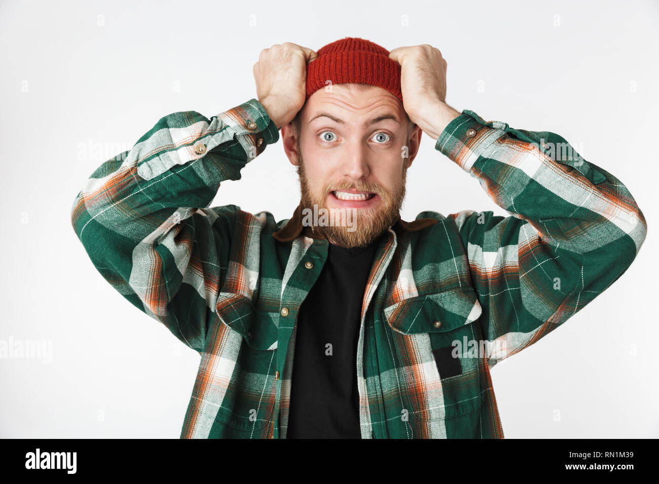 Portrait of uptight man wearing hat and plaid shirt screaming and ...