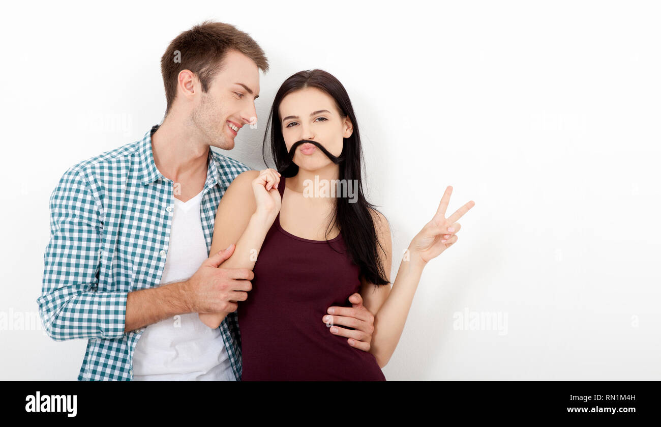 Playful couple fooling on valentine day. Beautiful young loving couple bonding to each other and ...