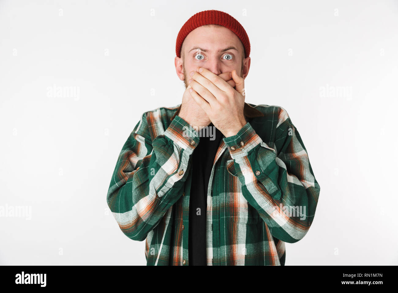 Portrait of scared bearded guy wearing hat and plaid shirt covering ...