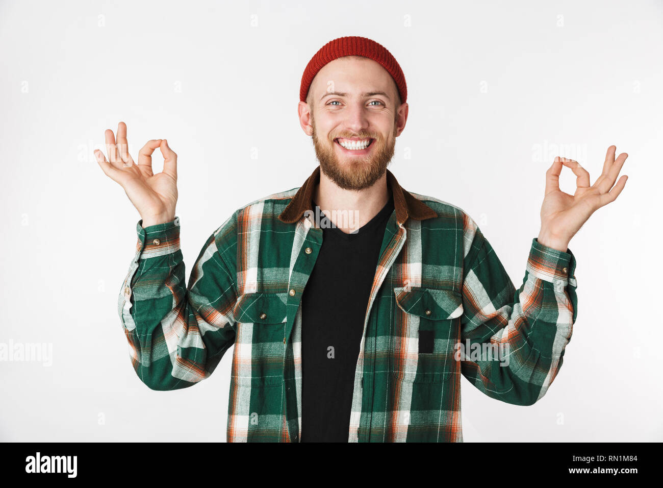 Portrait of smiling bearded guy wearing hat and plaid shirt showing ...