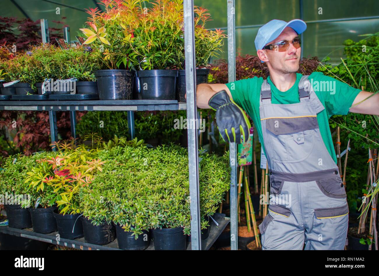 Garden Business Worker. Caucasian Worker in Front of Rack Full of ...