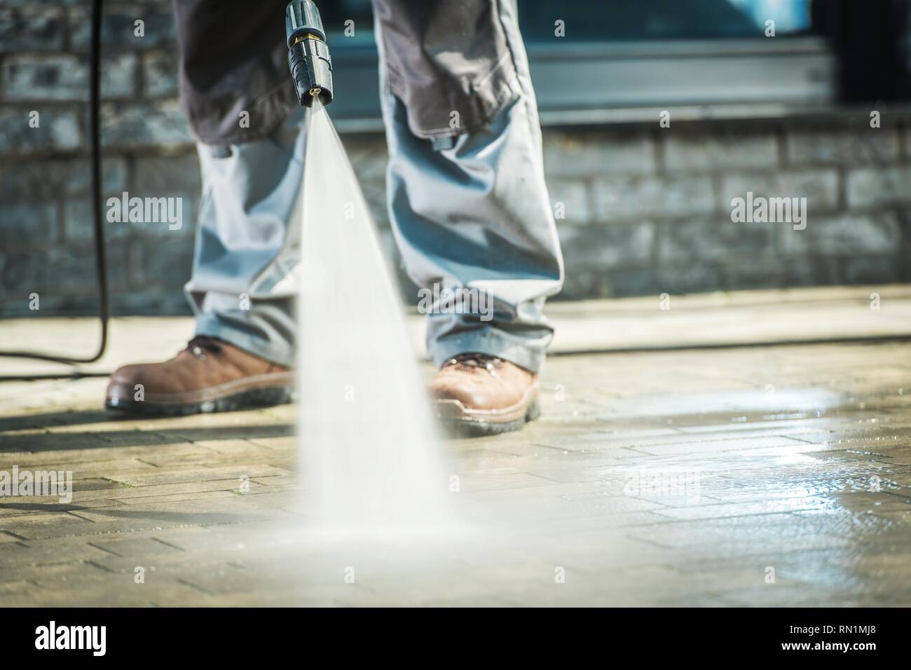 Men Using Pressure Washer For Driveway Cleaning Stock Photo - Alamy