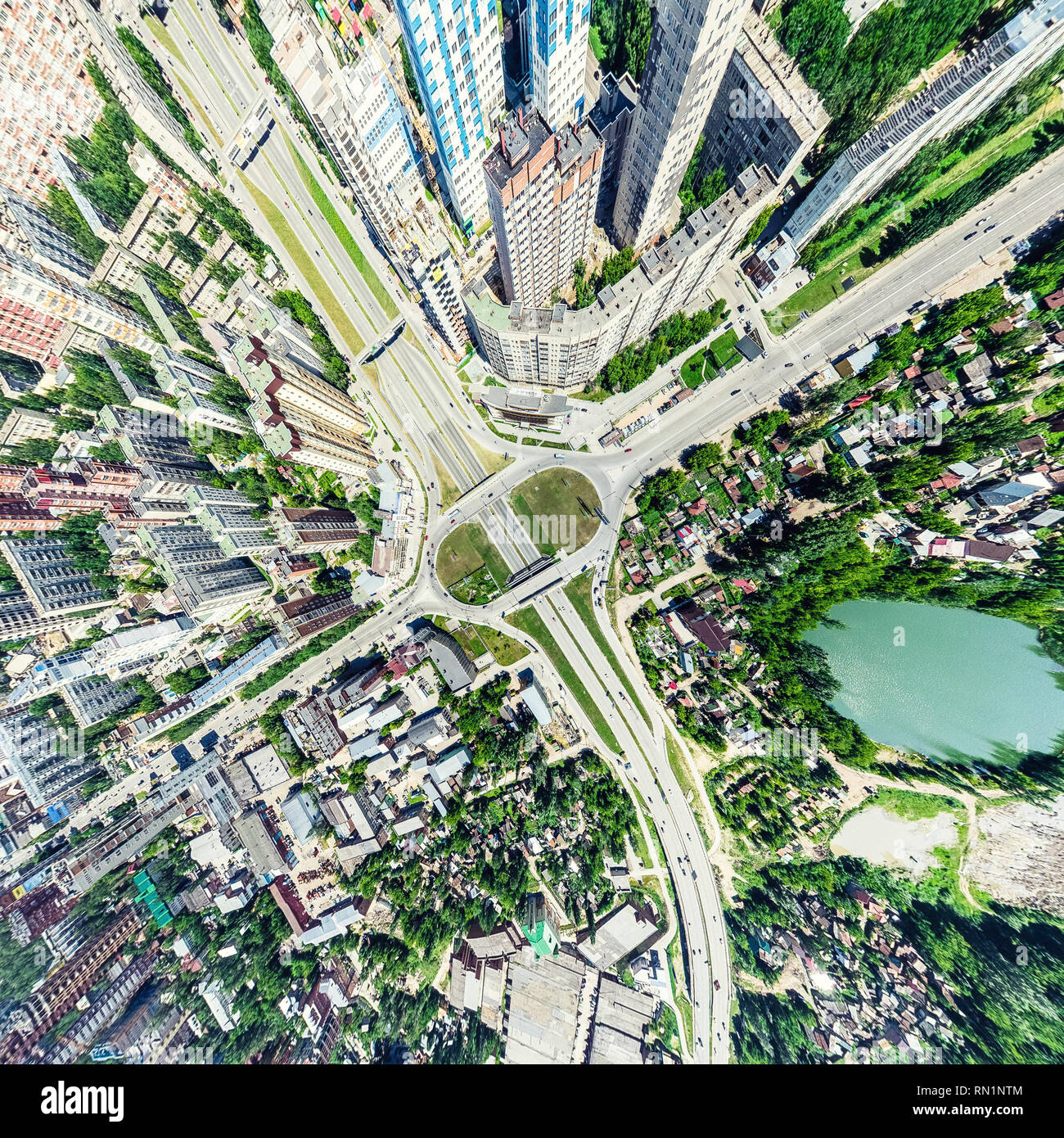 Aerial city view with crossroads and roads, houses, buildings, parks ...