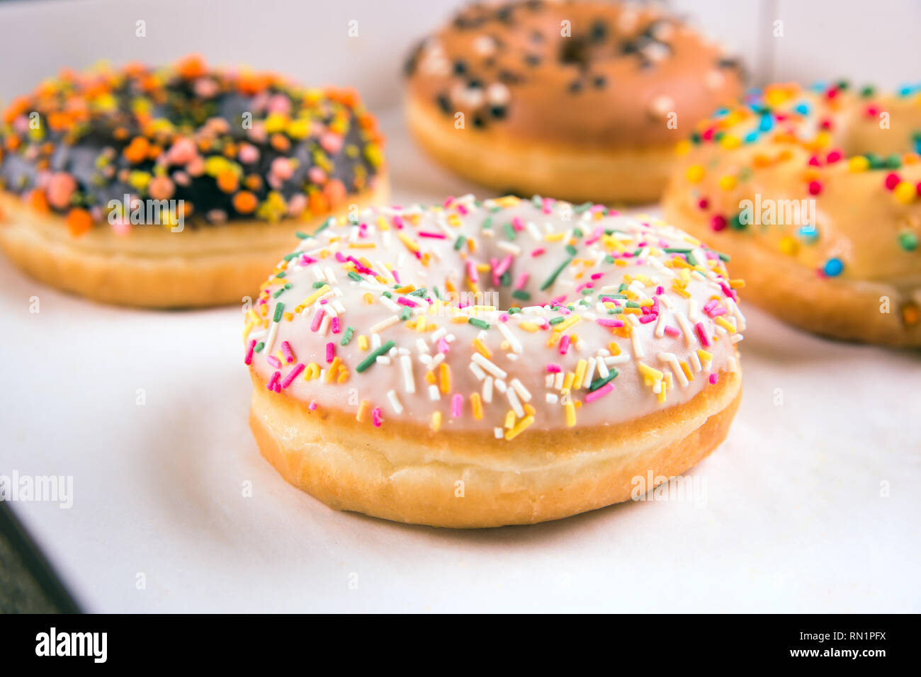 box of sweet fresh donuts with filling Stock Photo - Alamy