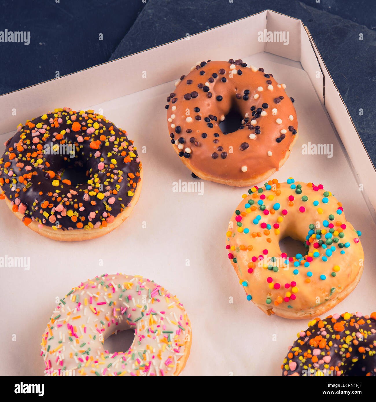 box of sweet fresh donuts with filling Stock Photo - Alamy