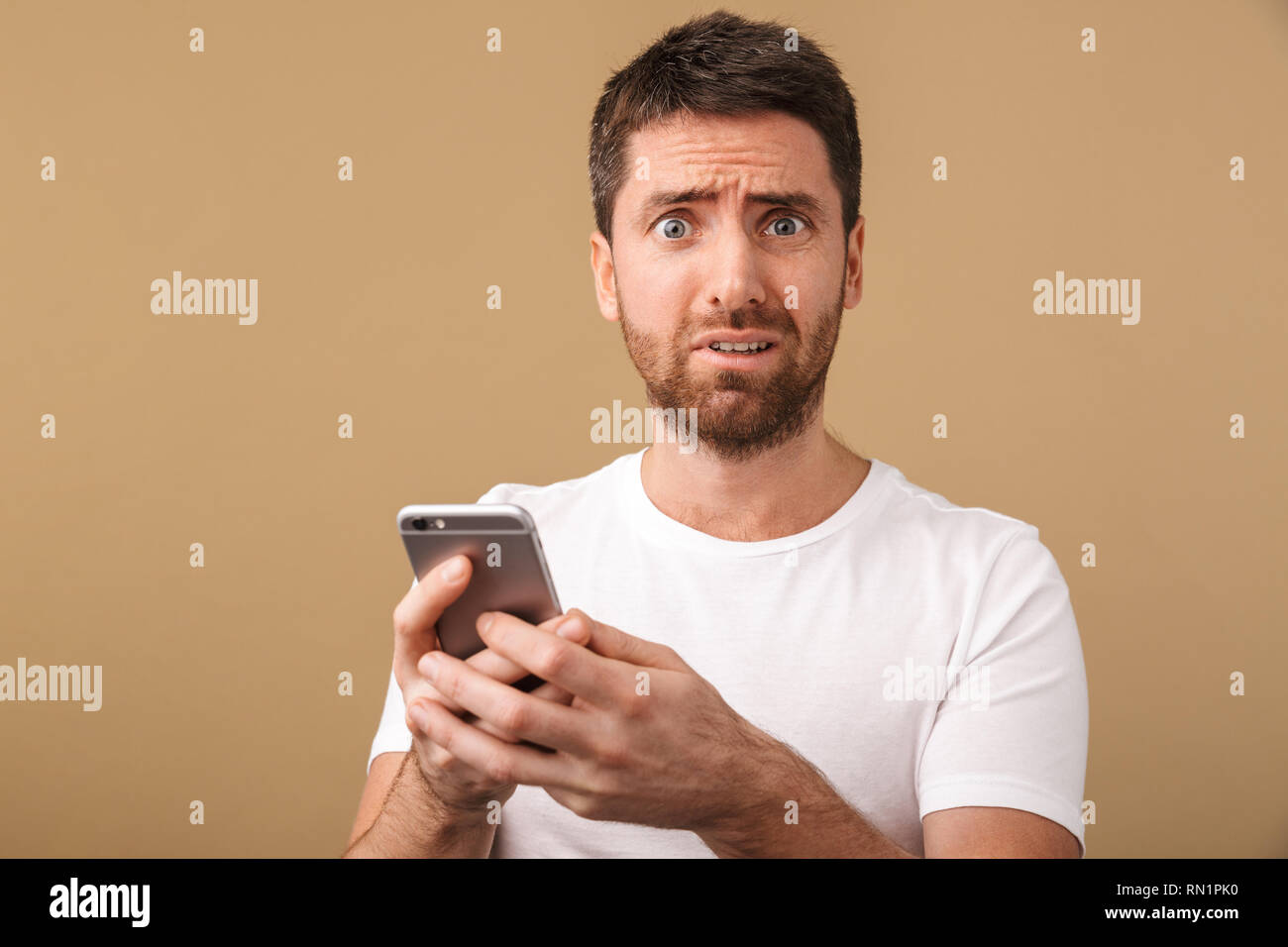 Confused man using smartphone text hi-res stock photography and images ...
