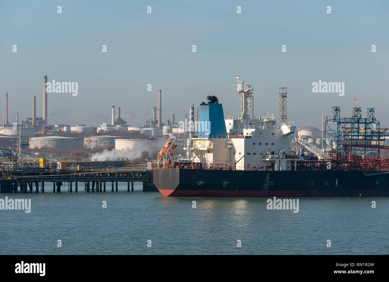 An oil products tanker vessel unloading on a refinery berth Stock Photo ...