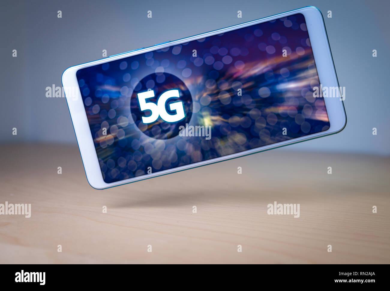 Smartphone device floating or levitating with 5G word on screen Stock ...