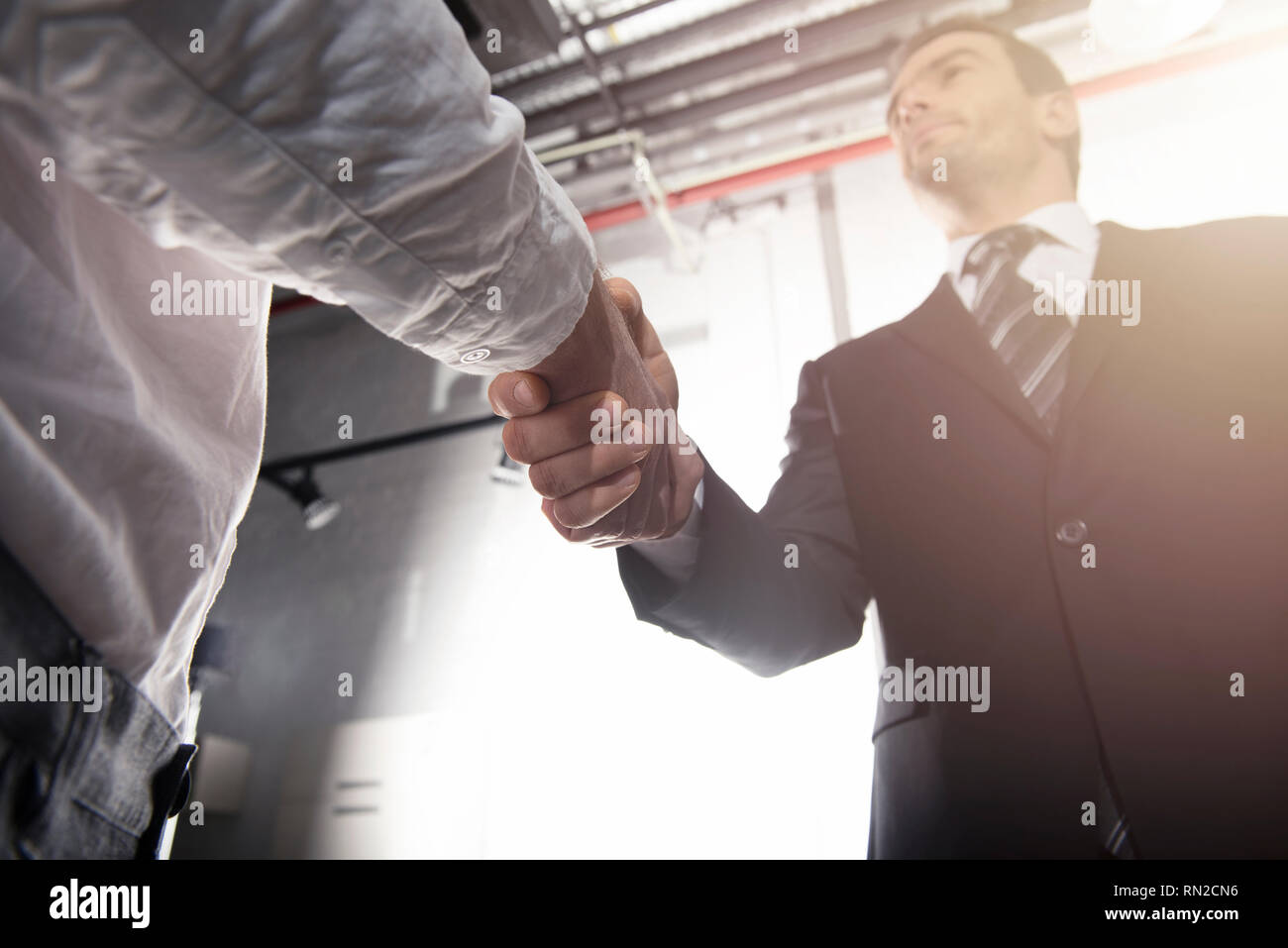 Handshaking business person in office. concept of teamwork and ...