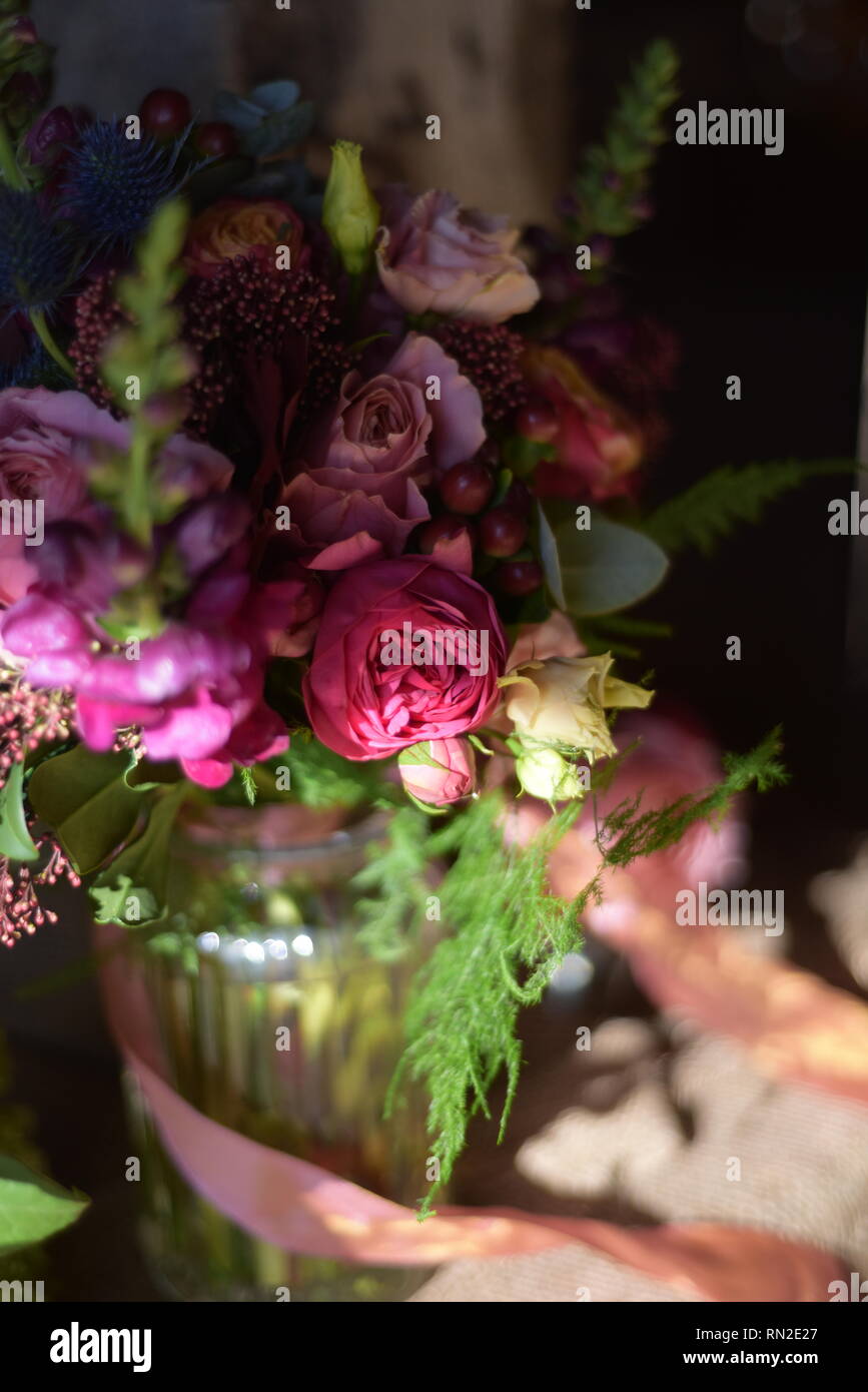 Beautiful vibrant cut flowers in a display in a strong low natural ...