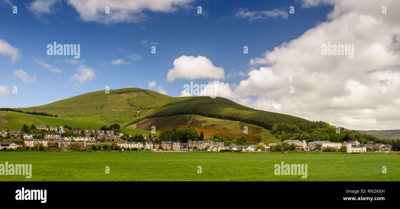 Sun shines on the houses of Walkerburn village, nestled under the ...