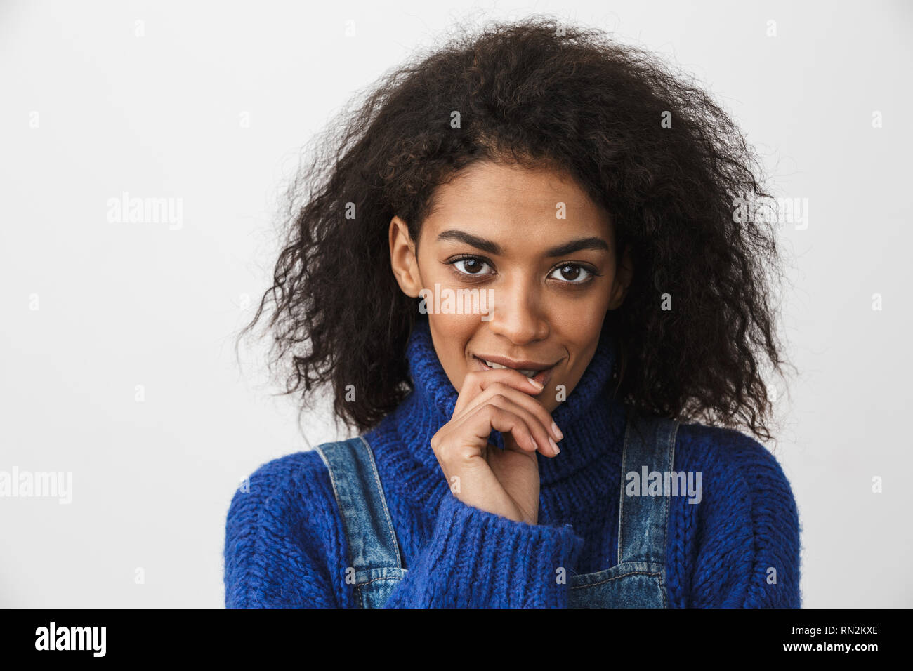 Close up of a pretty young african woman wearing sweater standing ...