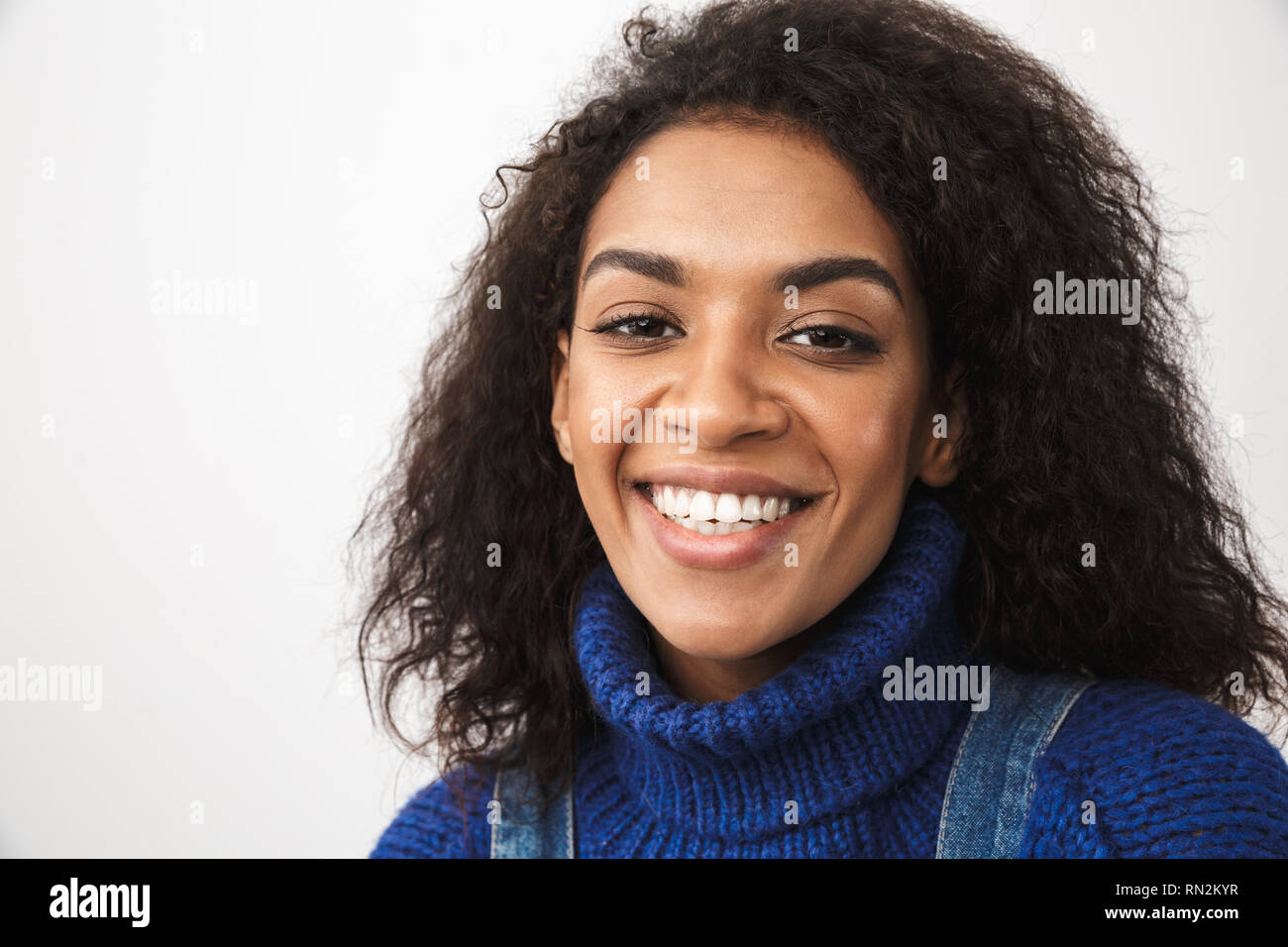 Close up of a pretty young african woman wearing sweater standing ...