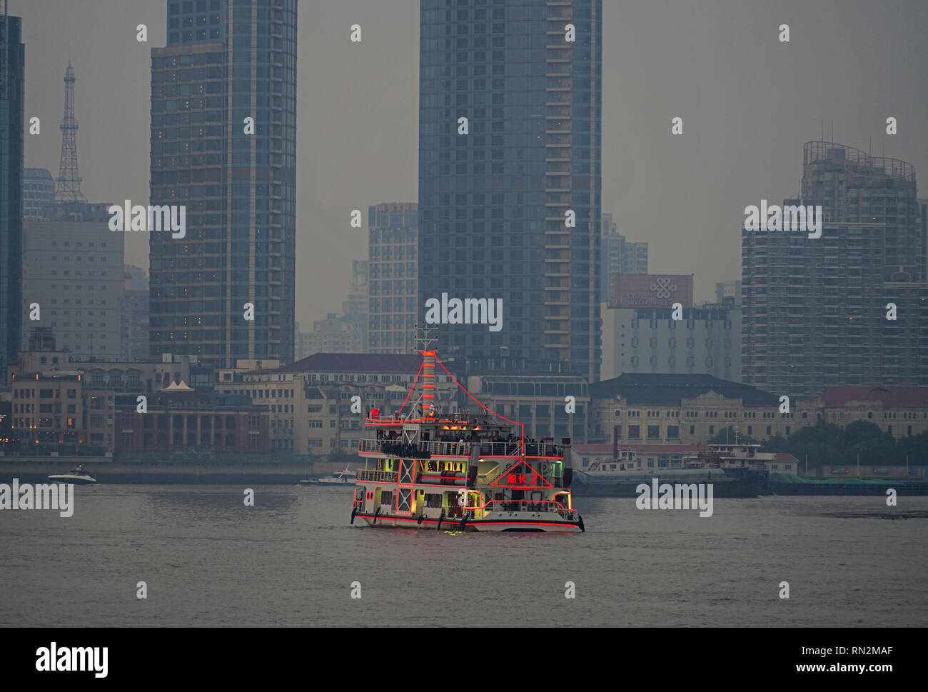 Sightseeing tourist cruise on Huangpu in evening in Shanghai Stock ...
