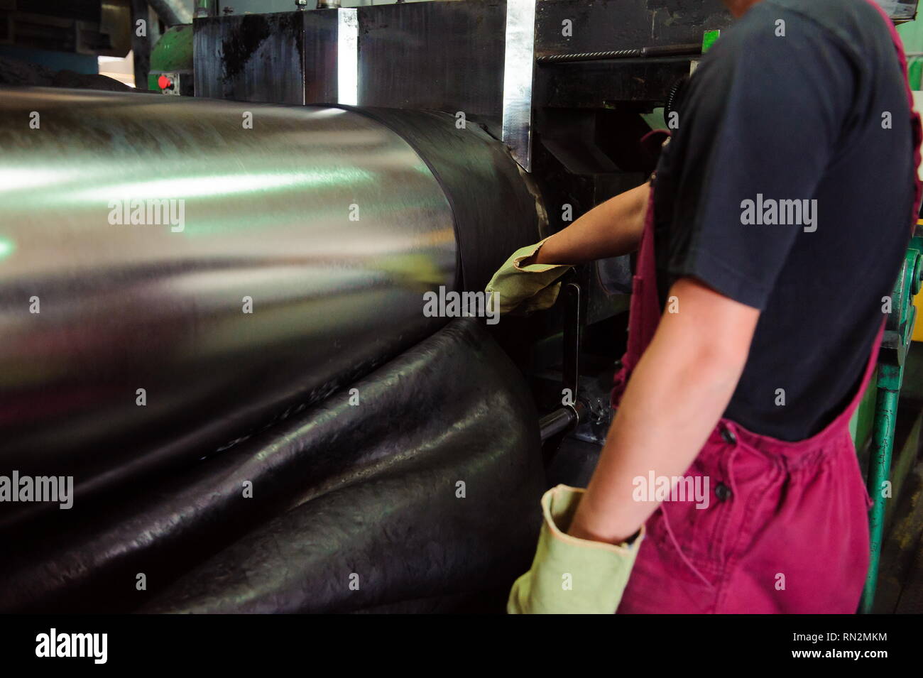Worker tests production at the rubber plant Stock Photo - Alamy
