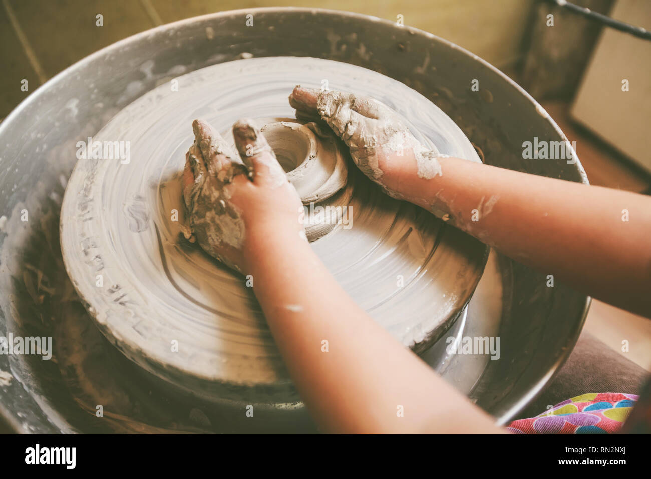 Young artist hands shaping clay on pottery wheel at workshop Stock ...