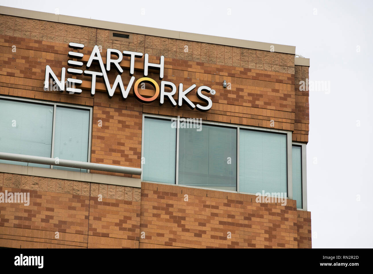 A logo sign outside of the headquarters of Earth Networks in Germantown ...