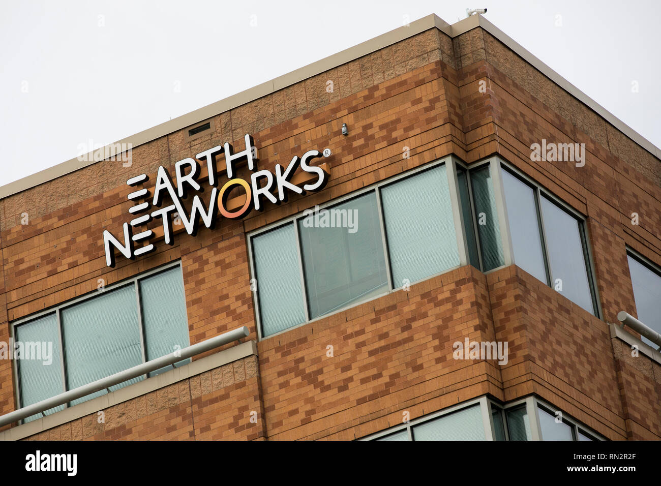 A logo sign outside of the headquarters of Earth Networks in Germantown ...
