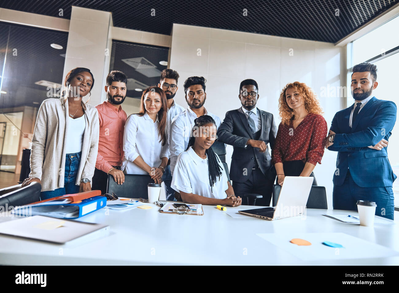 beautiful african boss sitting on the chair while her workers are ...