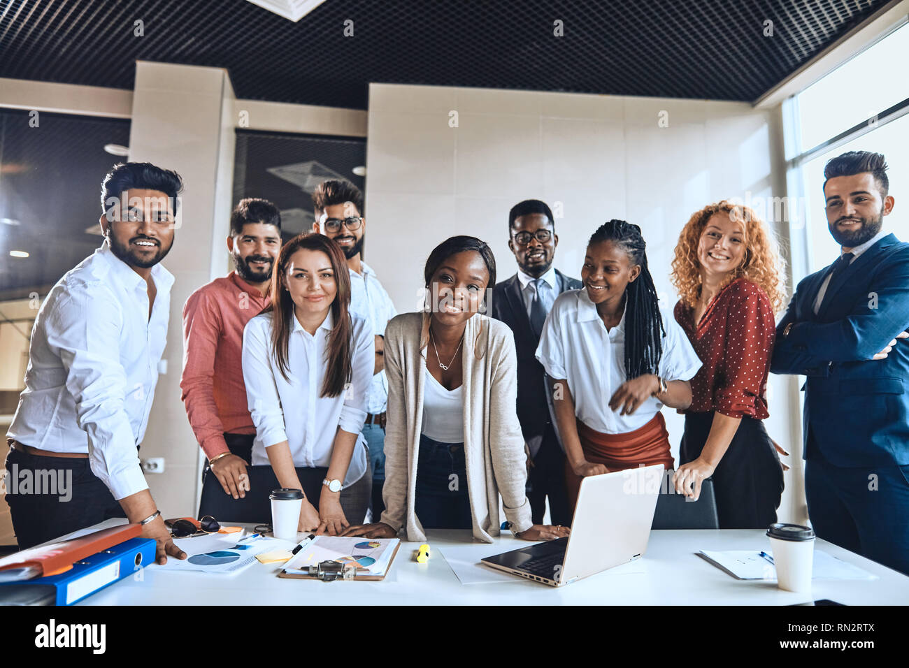 charming afro boss leading young active diverse people. talented female ...